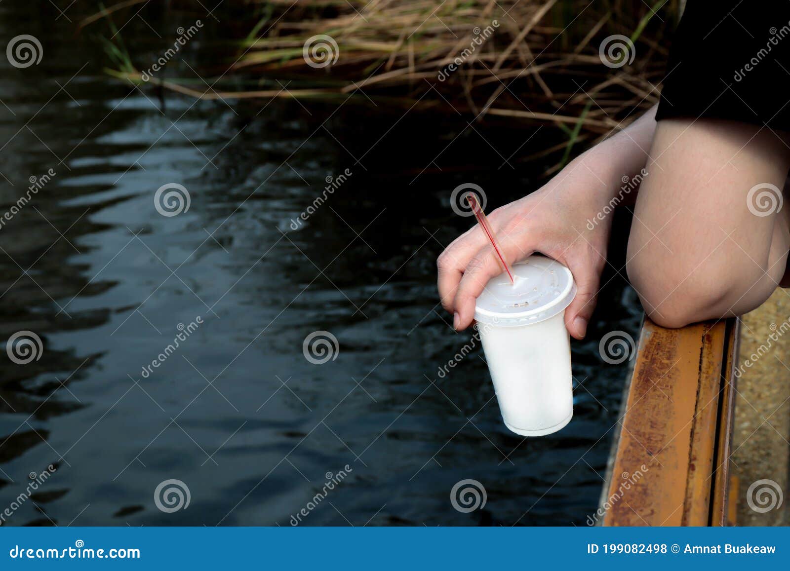 Plastic Water Cup in Hand Holding at River, Plastic Garbage Waste Cup ...