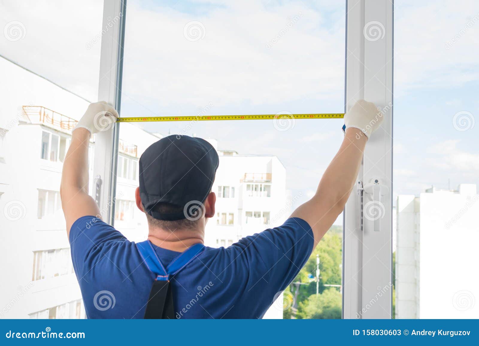A Plastic Window Installation Worker Measures the Light Opening of a ...