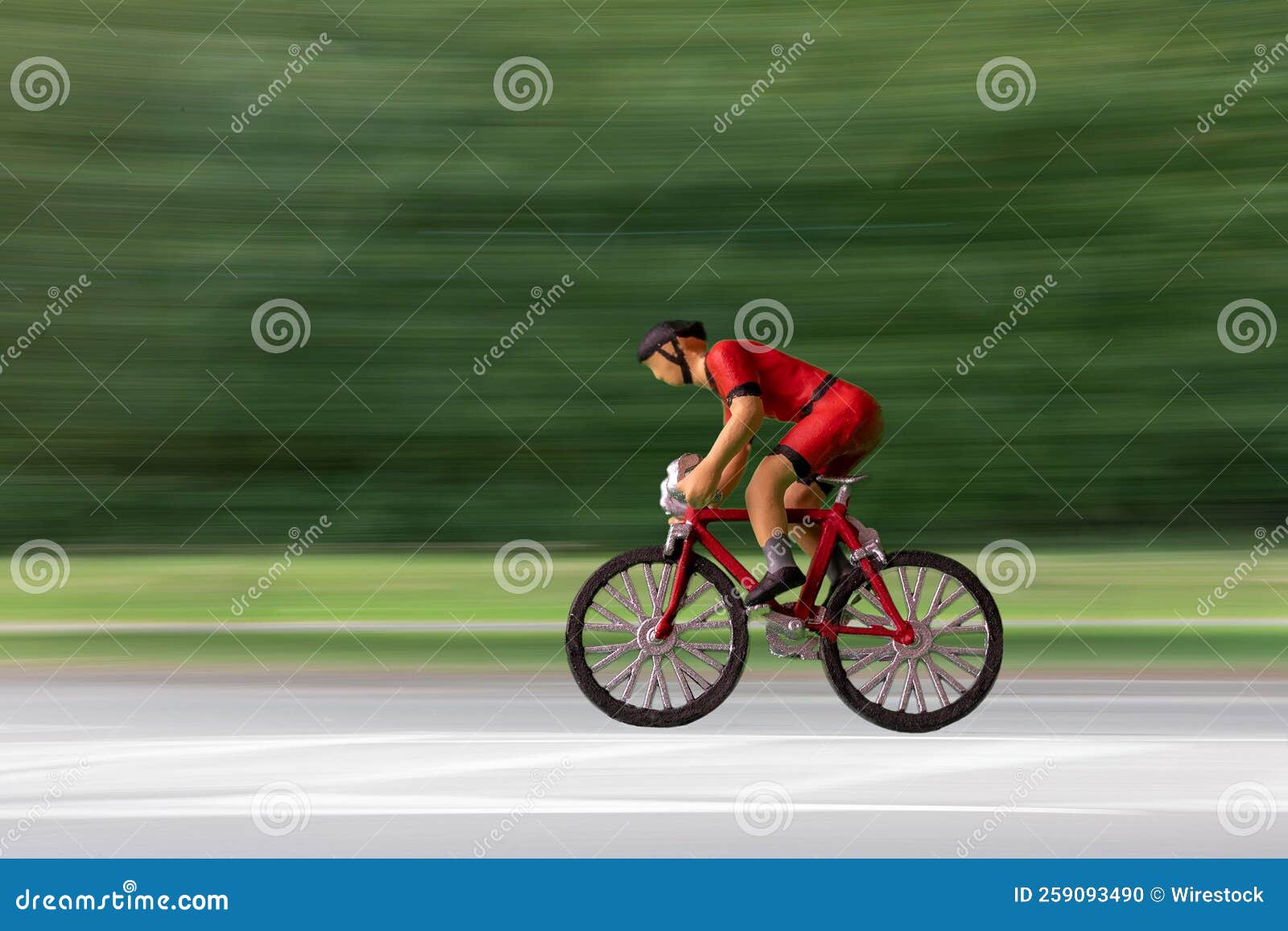 Plasticine Dummy of a Cyclist Pedaling with a Green Blurred Background ...