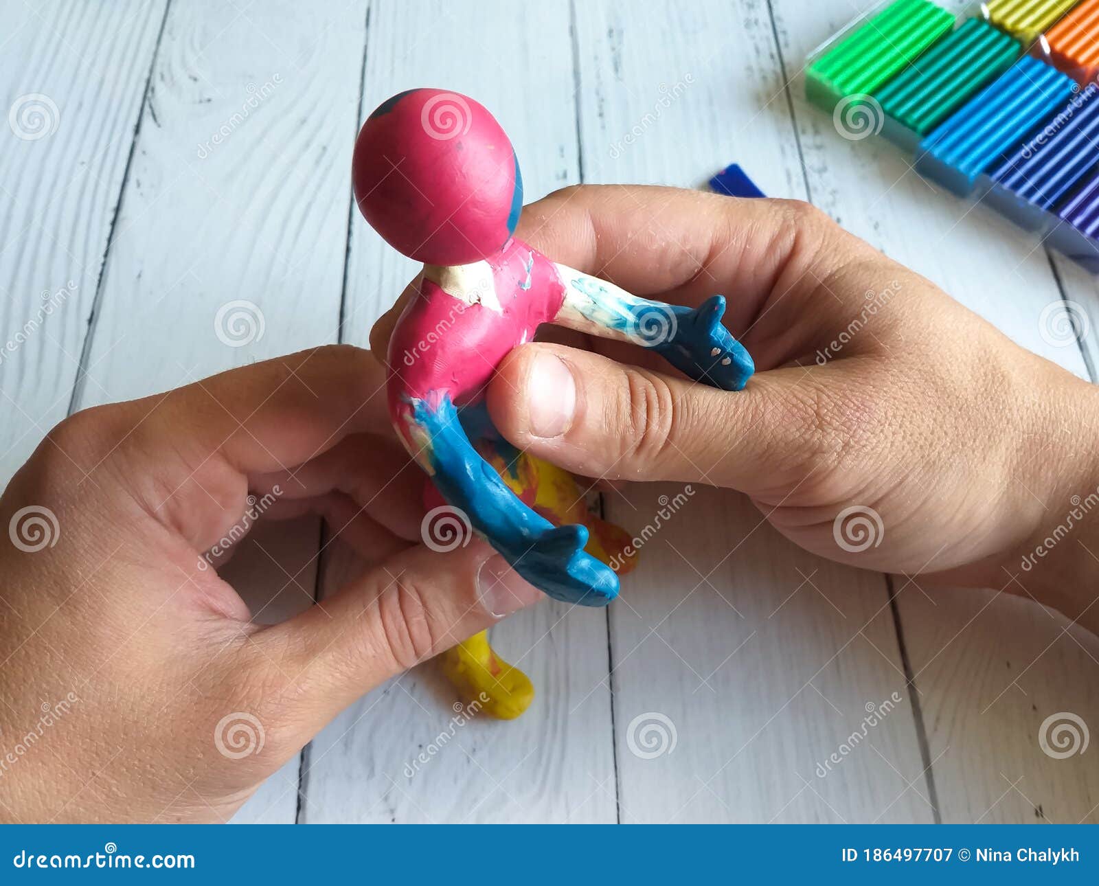 Plasticine Modeling. Hands of a Male Master Hold a Human Figure from ...