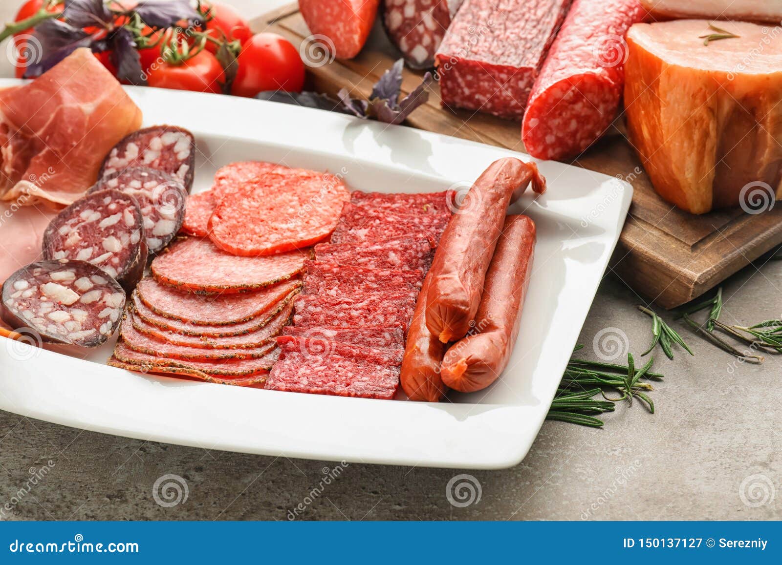 Plate and Board with Assortment of Delicious Deli Meats on Table Stock ...