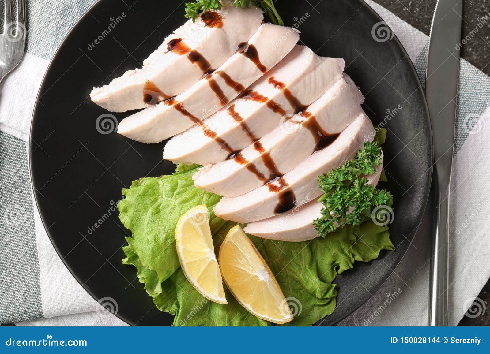 Plate with Boiled Chicken Fillet and Garnish on Table Stock Photo ...