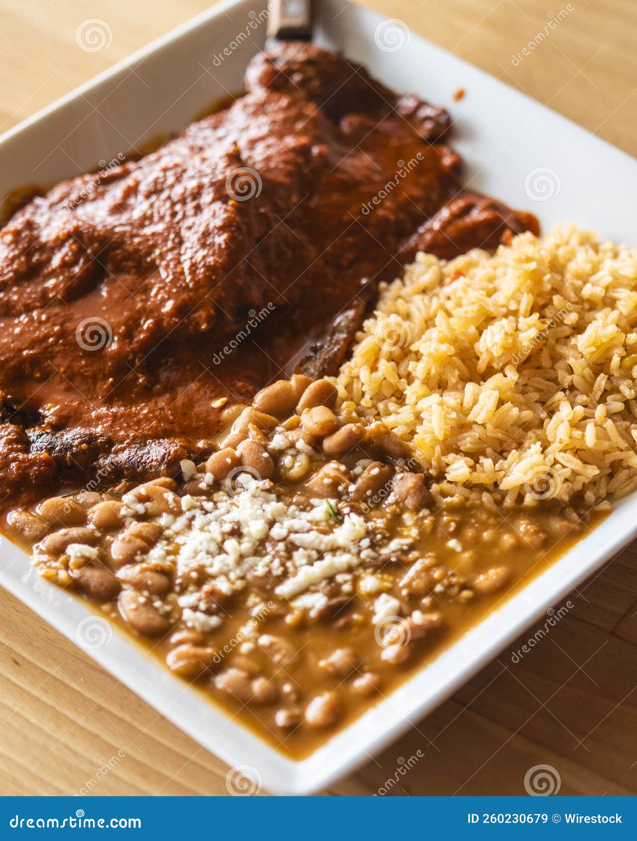 Plate of Charro Beans and Rice with a Side of Mole on a Wooden Surface ...