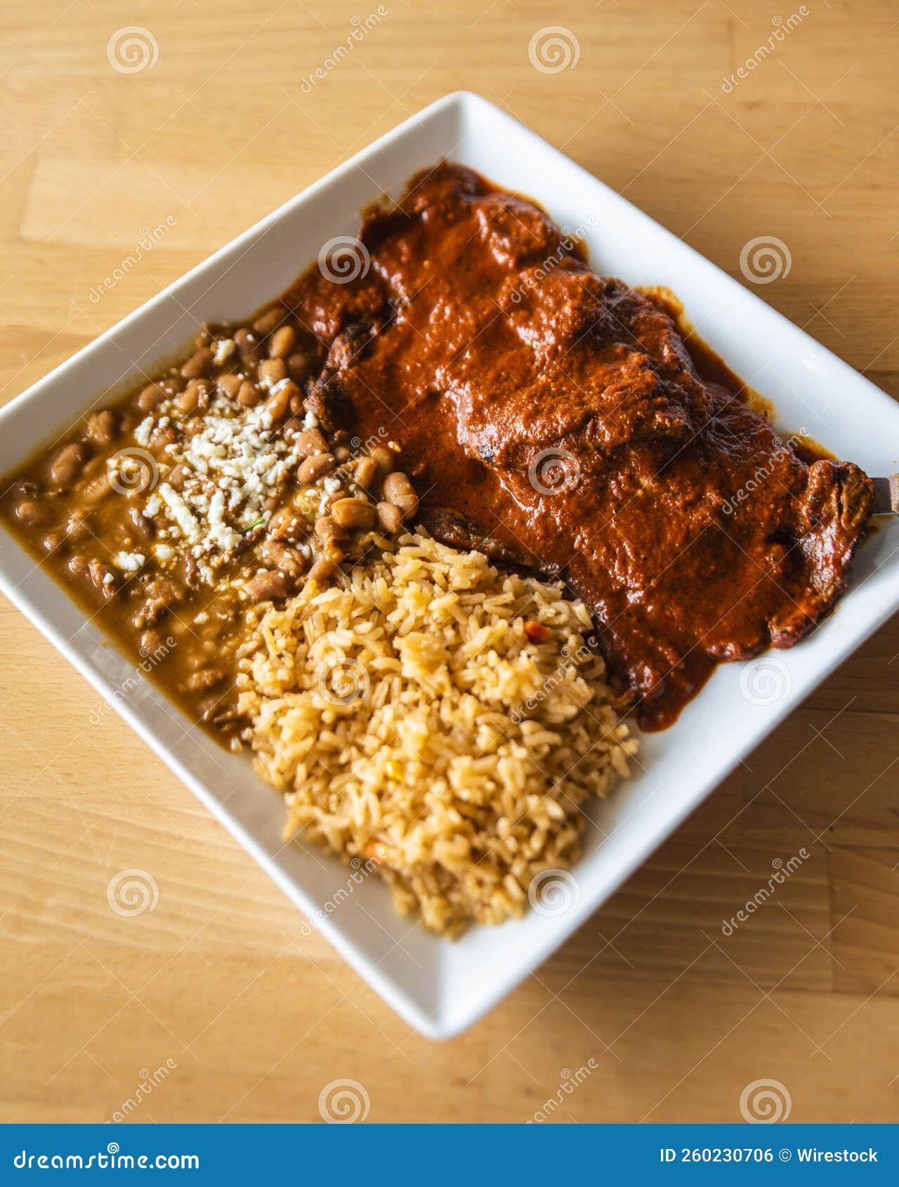 Plate of Charro Beans and Rice with a Side of Mole on a Wooden Surface ...