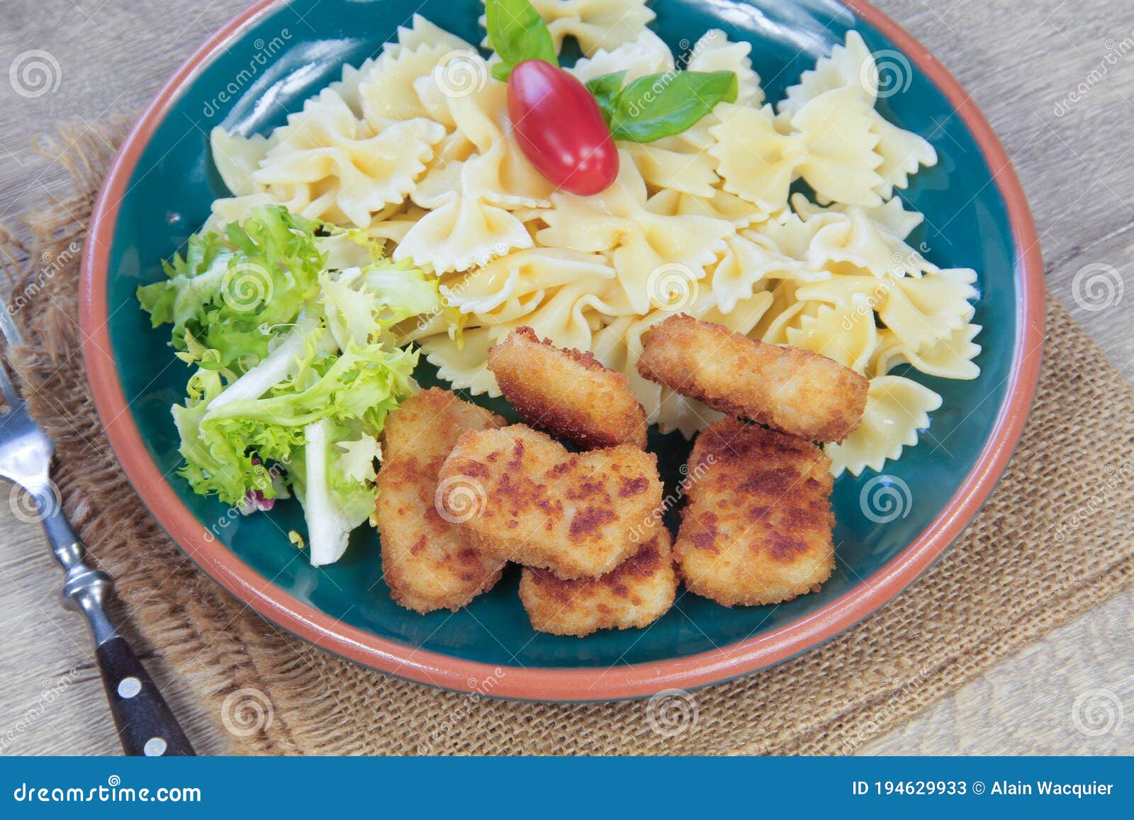 Plate of Chicken Nuggets and Pasta Stock Image - Image of breading ...