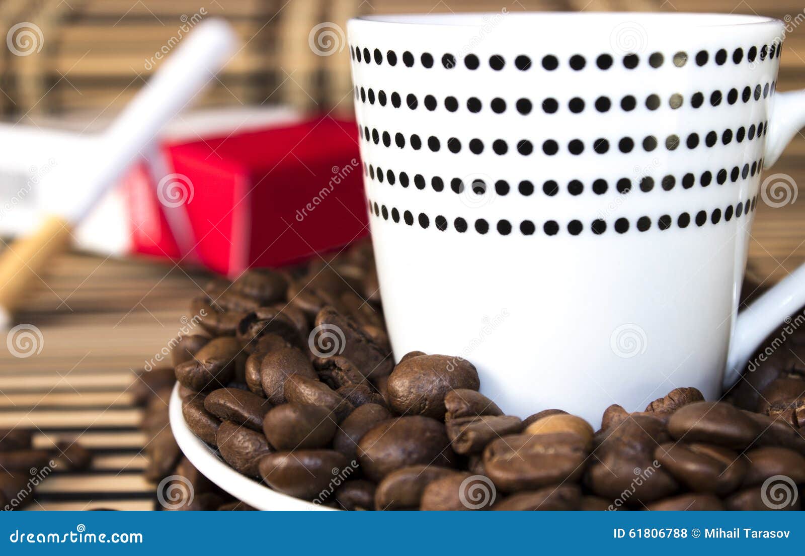 Plate with Coffee Beans and Dotted Cup in Front of a Cigarette Stock ...