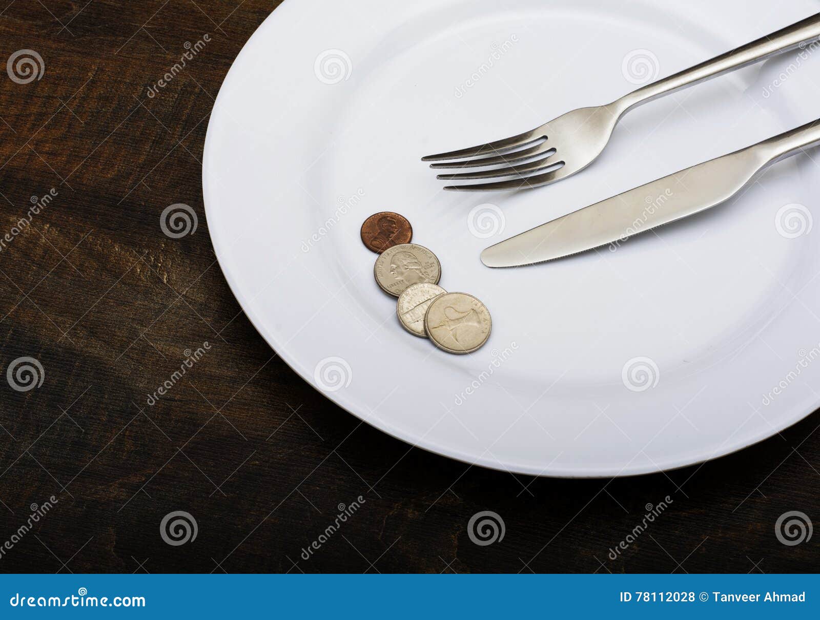 Plate with Coins and Knife with Fork on Wooden Background Stock Photo ...