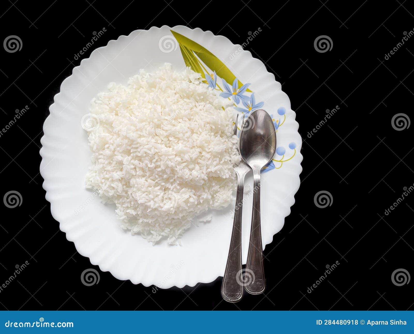 A Plate of Cooked Steam Rice with Fork and Spoon Display on Black ...