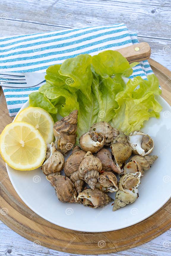 Plate of Cooked Whelks on a Table Stock Photo - Image of cooked ...