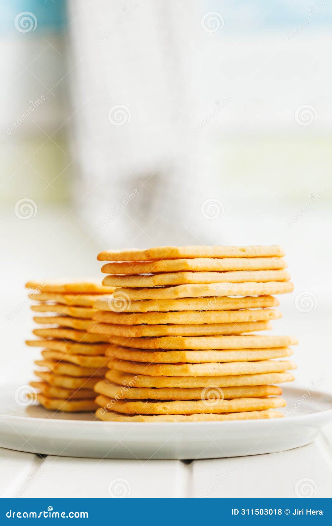 Plate of Crackers on White Table Stock Photo - Image of appetizer ...