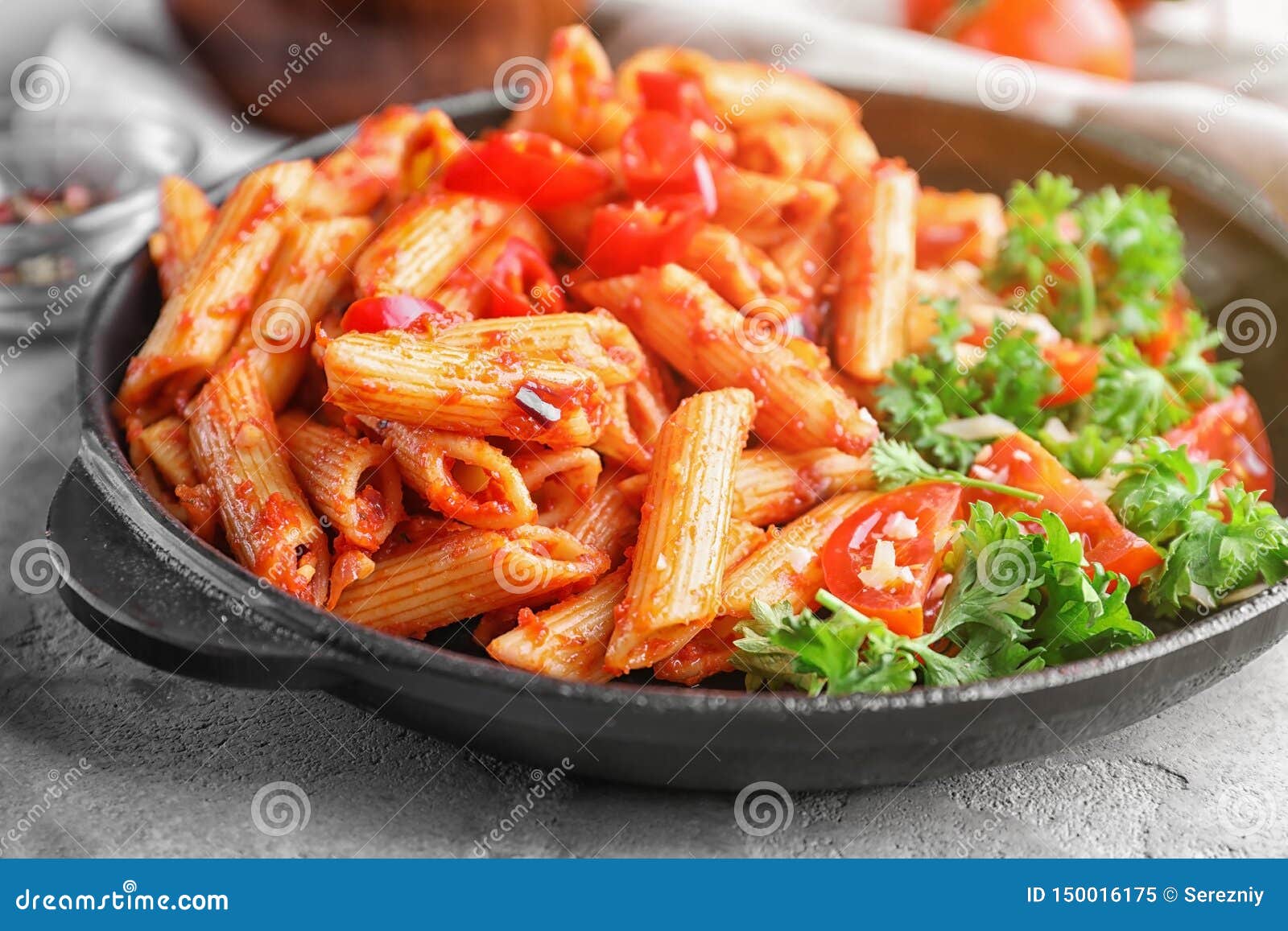 Plate with Delicious Penne Pasta and Garnish on Table, Closeup Stock ...