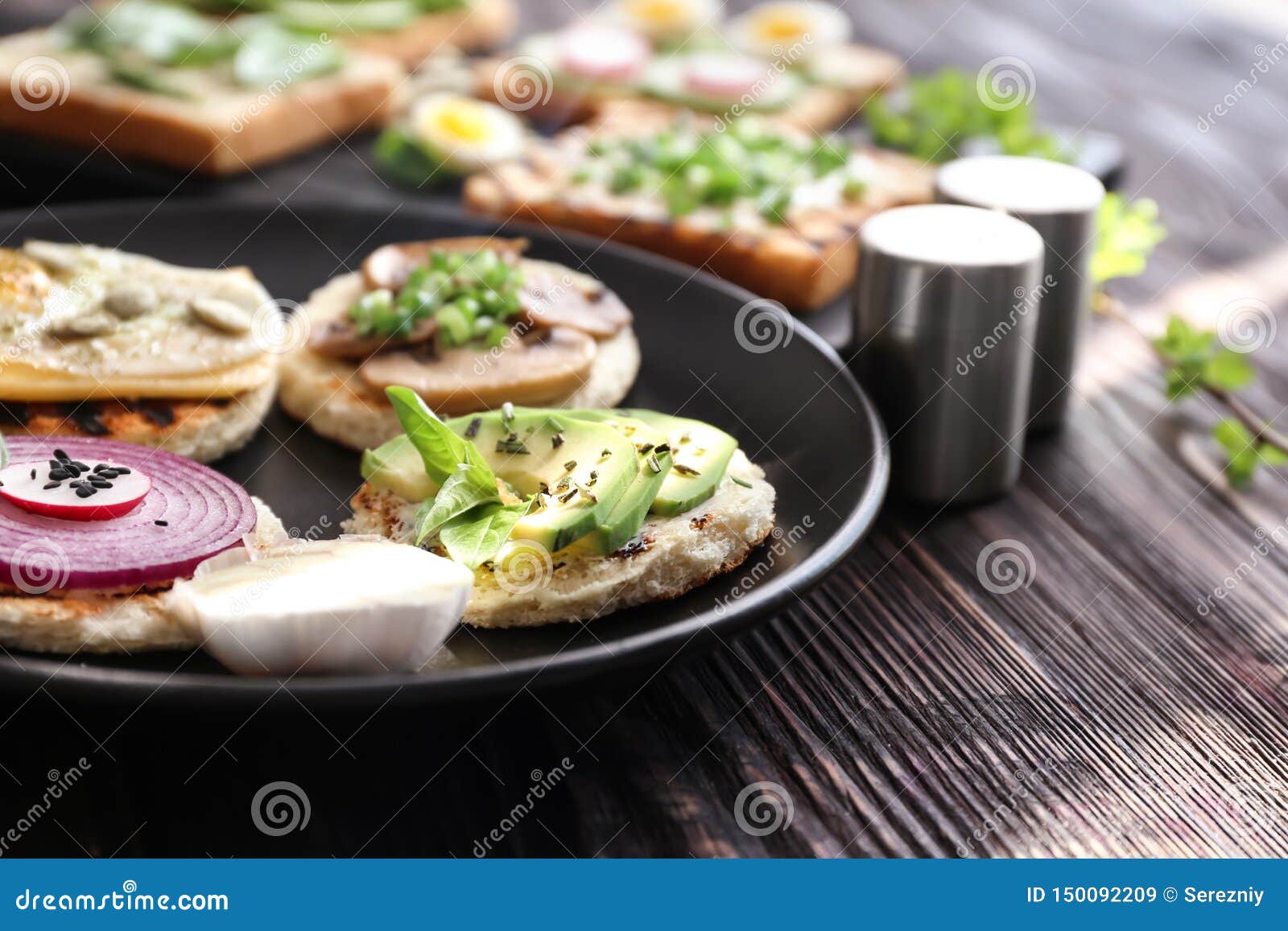 Plate with Different Delicious Toasts on Table Stock Image - Image of ...