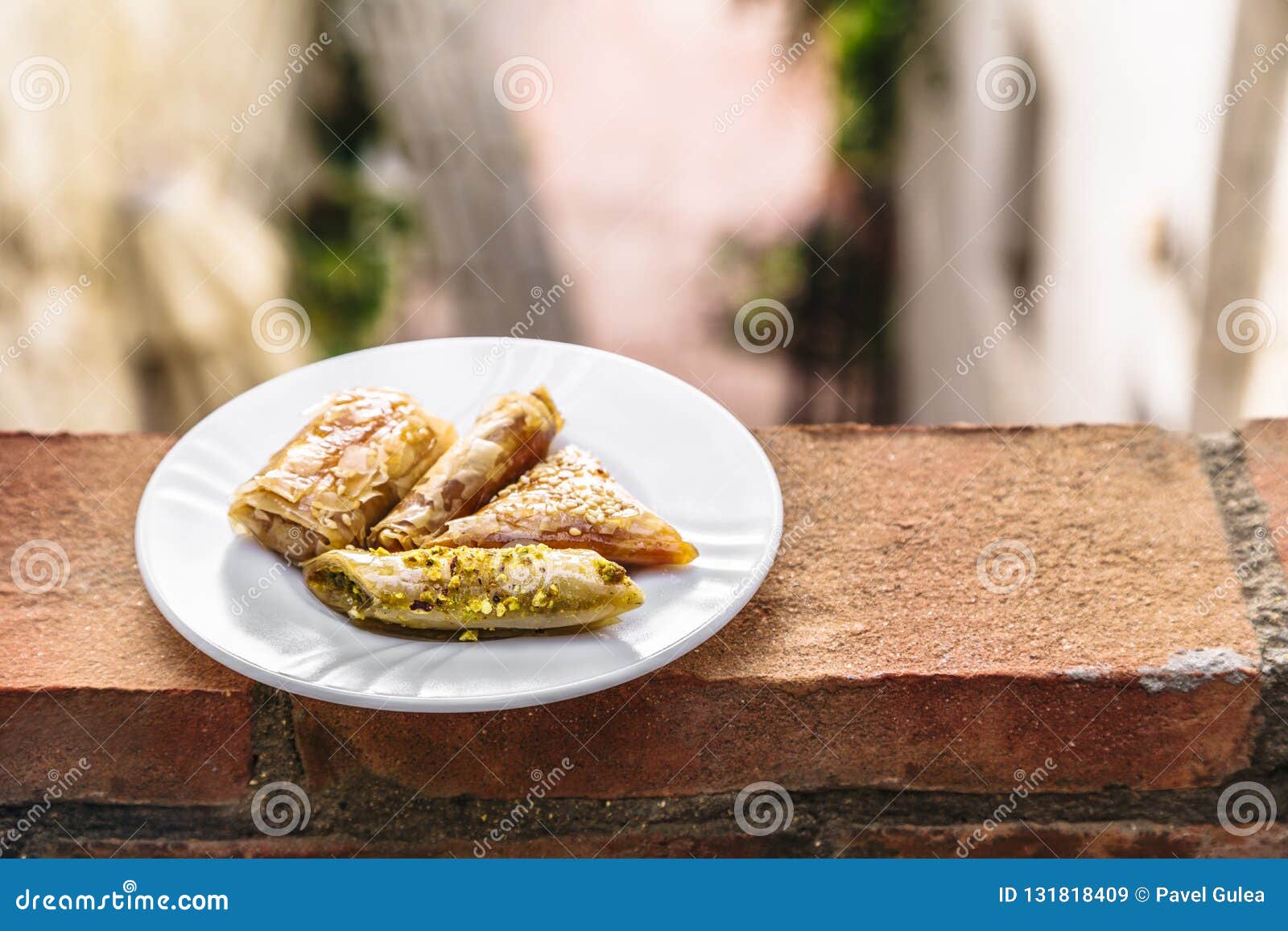 Plate with Different Sweets are on Edge of Brick Fence Stock Image ...