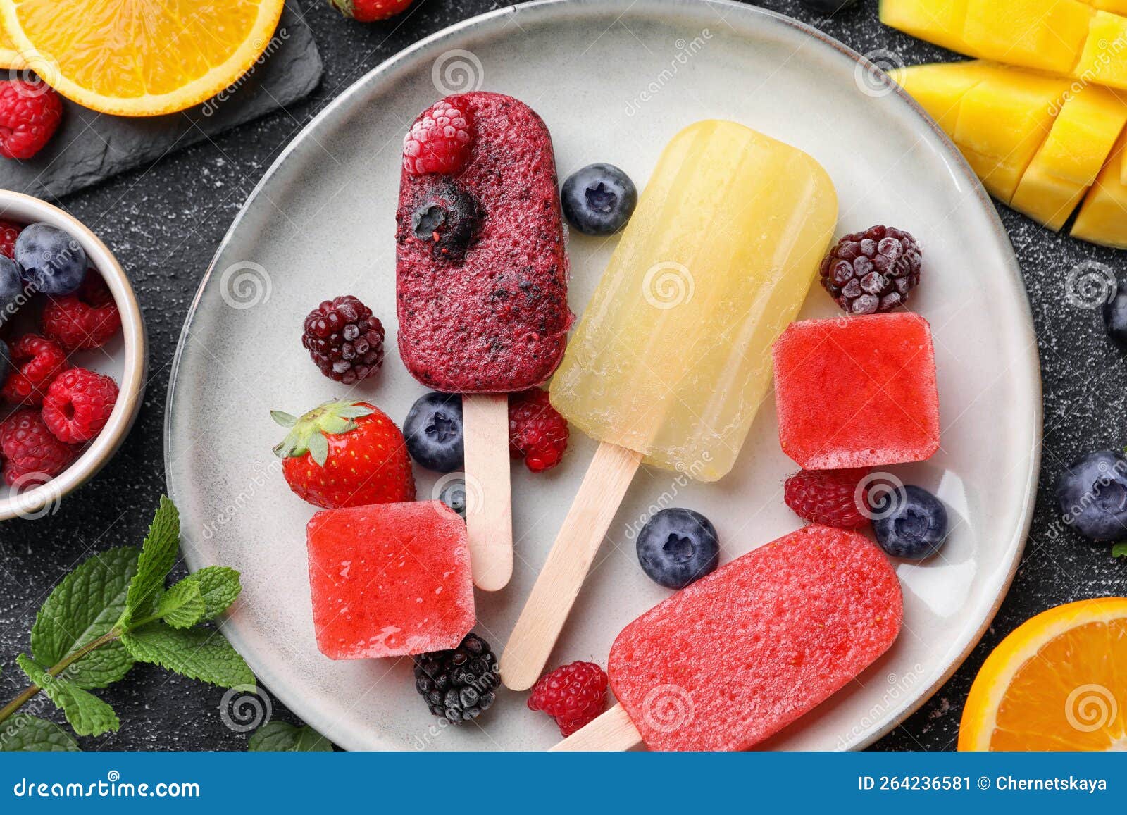 Plate of Different Tasty Ice Pops on Black Textured Table, Flat Lay ...