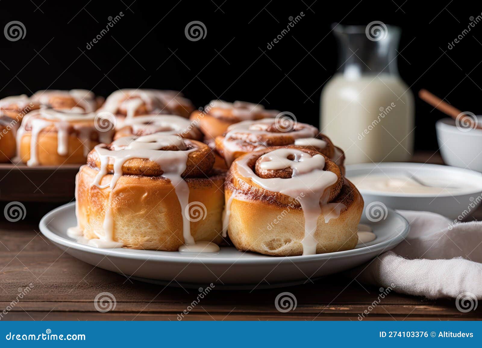 A Plate of Fluffy Cinnamon Buns Topped with Sweet Icing Stock ...