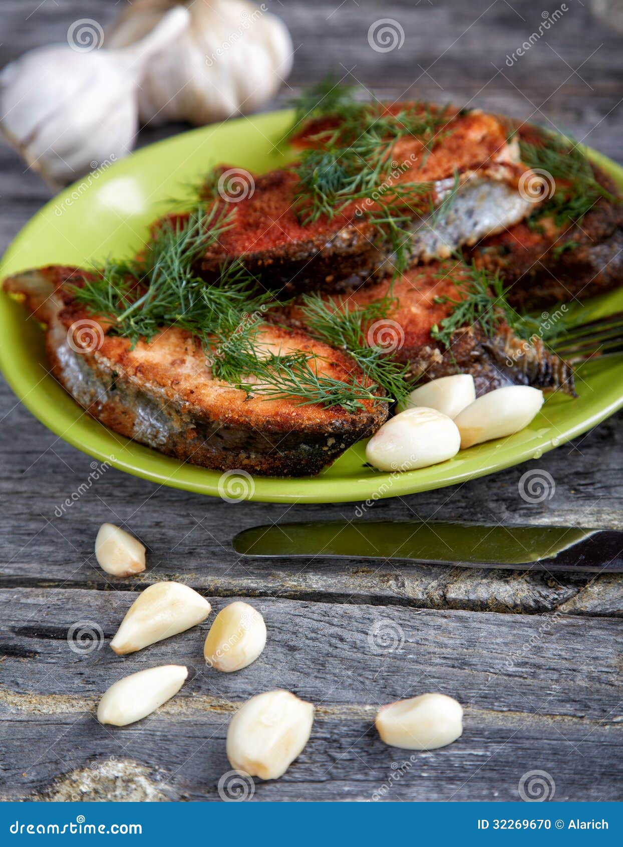 Plate with Fried Fish and Garlic on a Table Stock Photo - Image of ...