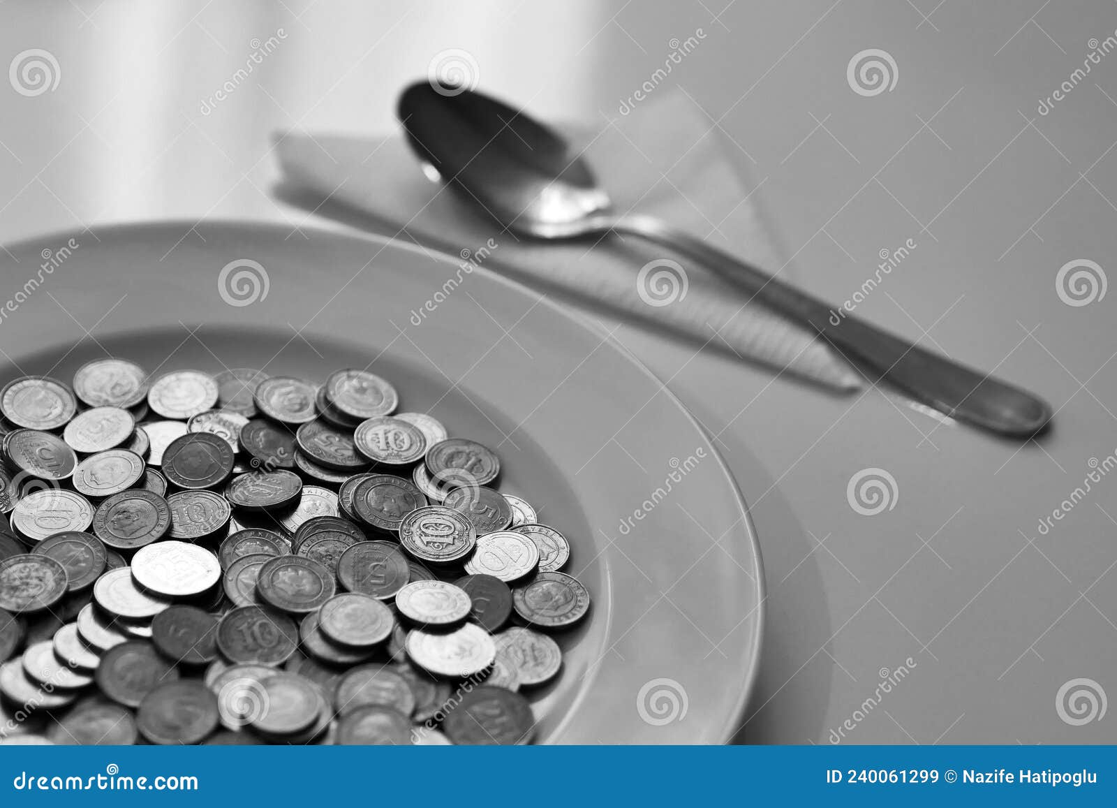 A Plate Full of Coins on a Table and a Spoon Next To it, Eating Money ...