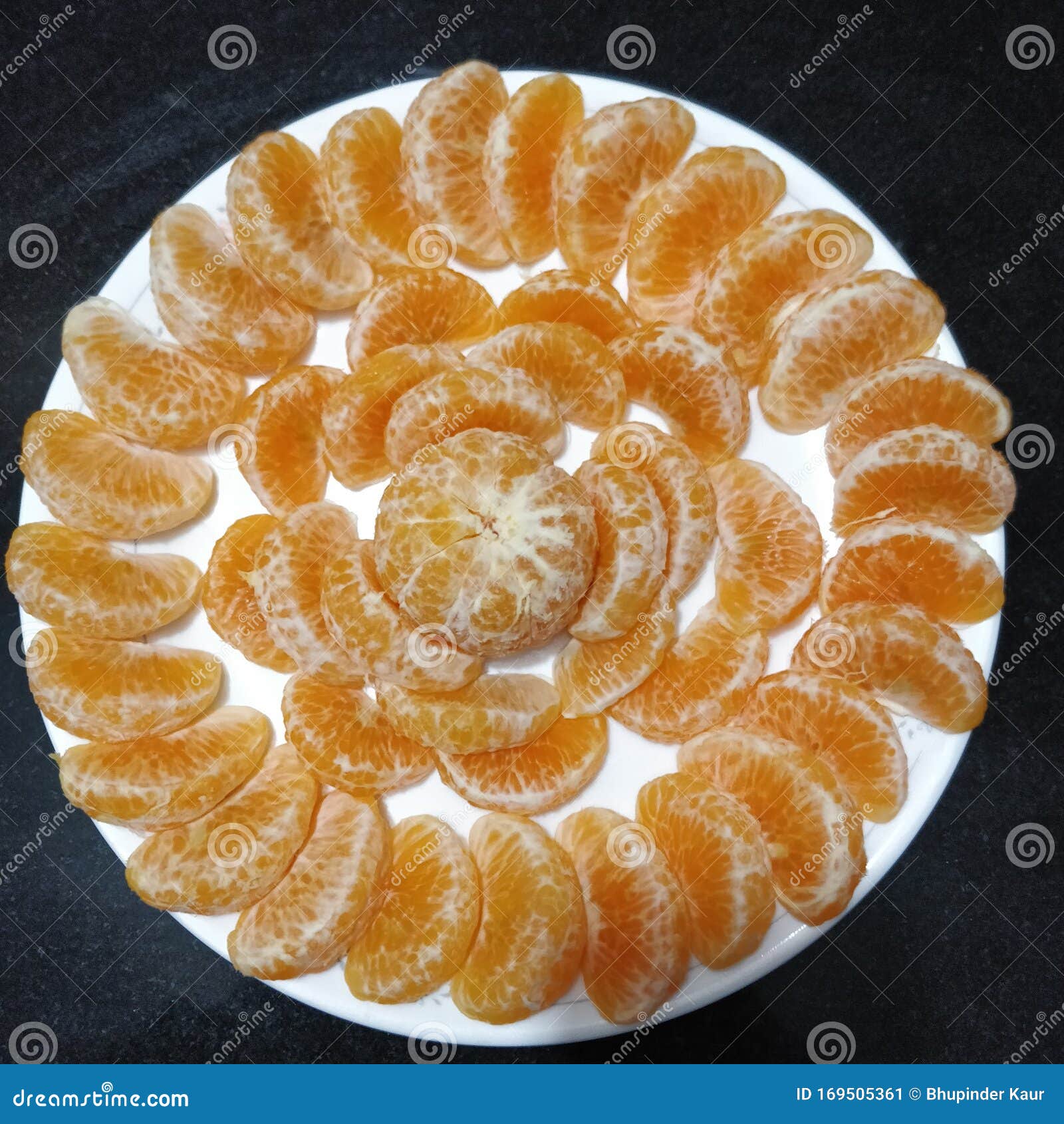 Plate Full of Kinnow Segments and a Peeled Kinnow Stock Image - Image ...