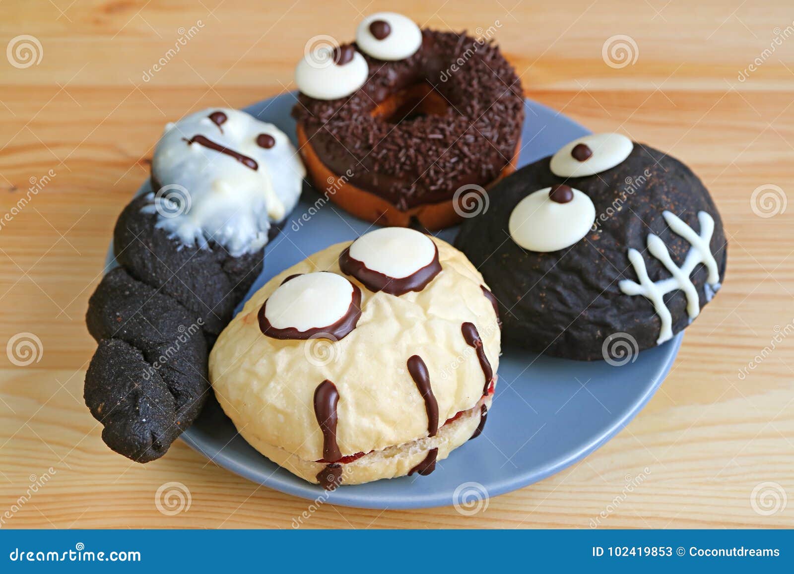 Plate of Halloween Monsters and Ghosts Shaped Doughnuts Served on ...