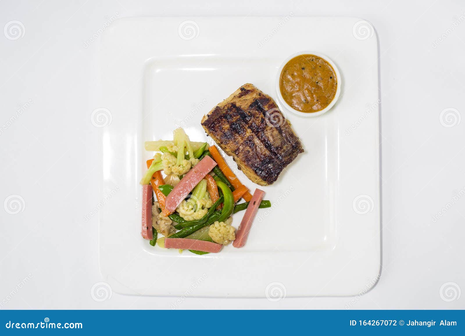 A Plate of Hot Fish Stake with Sauce and Mixed Thai Vegetabls. Top View ...