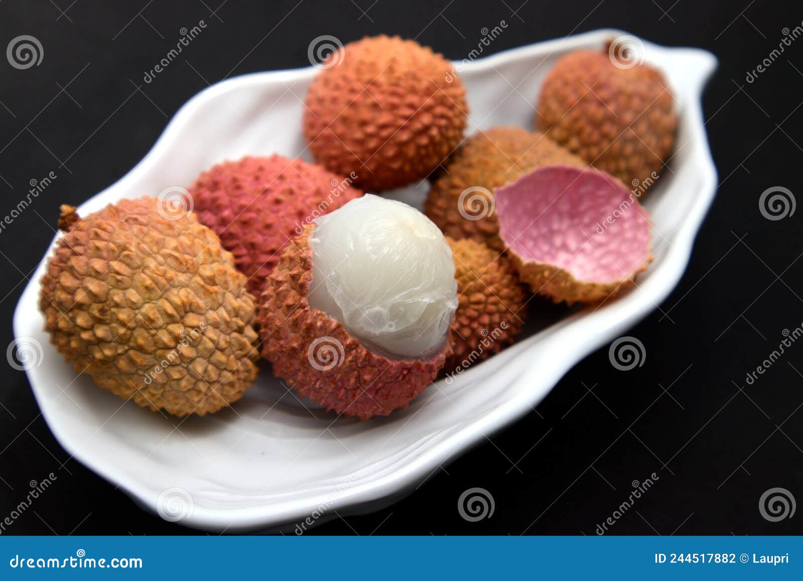 A Plate with Lychees on a Black Surface Stock Photo - Image of fruits ...