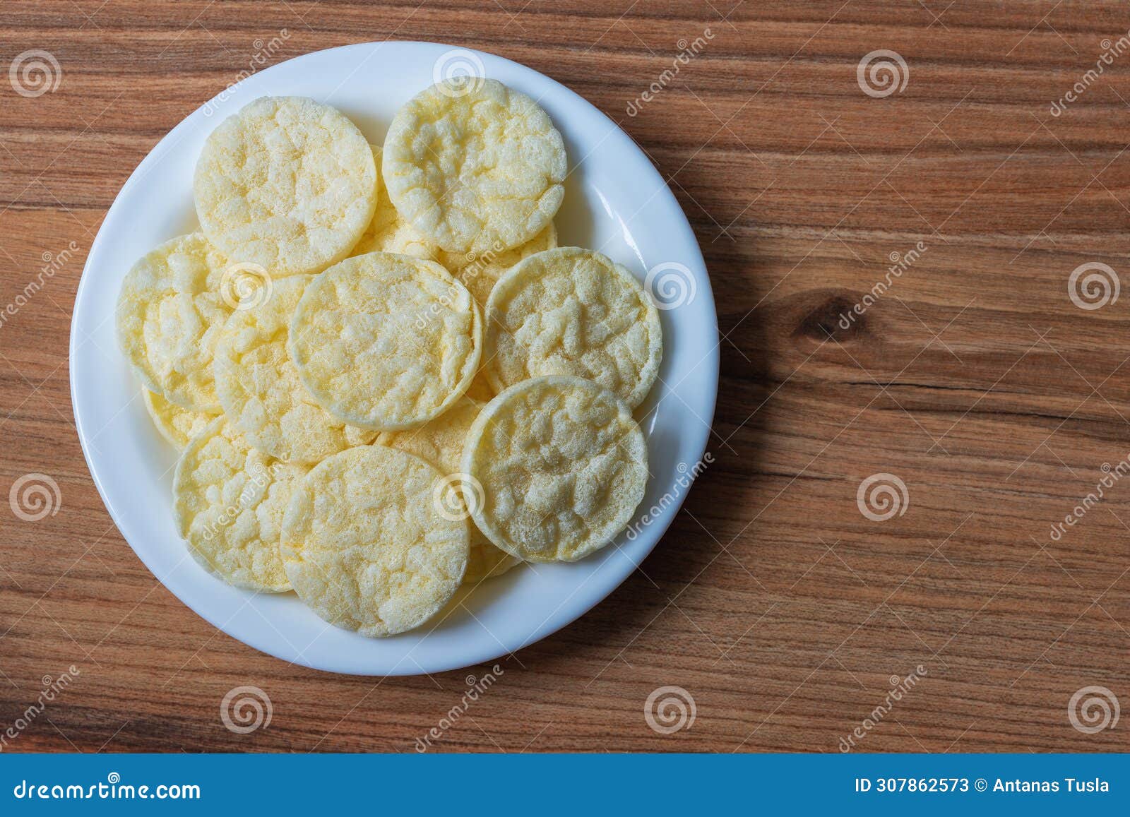 A Plate of Many Round Rice Chips with Cheese Flavor on a Pine Table ...