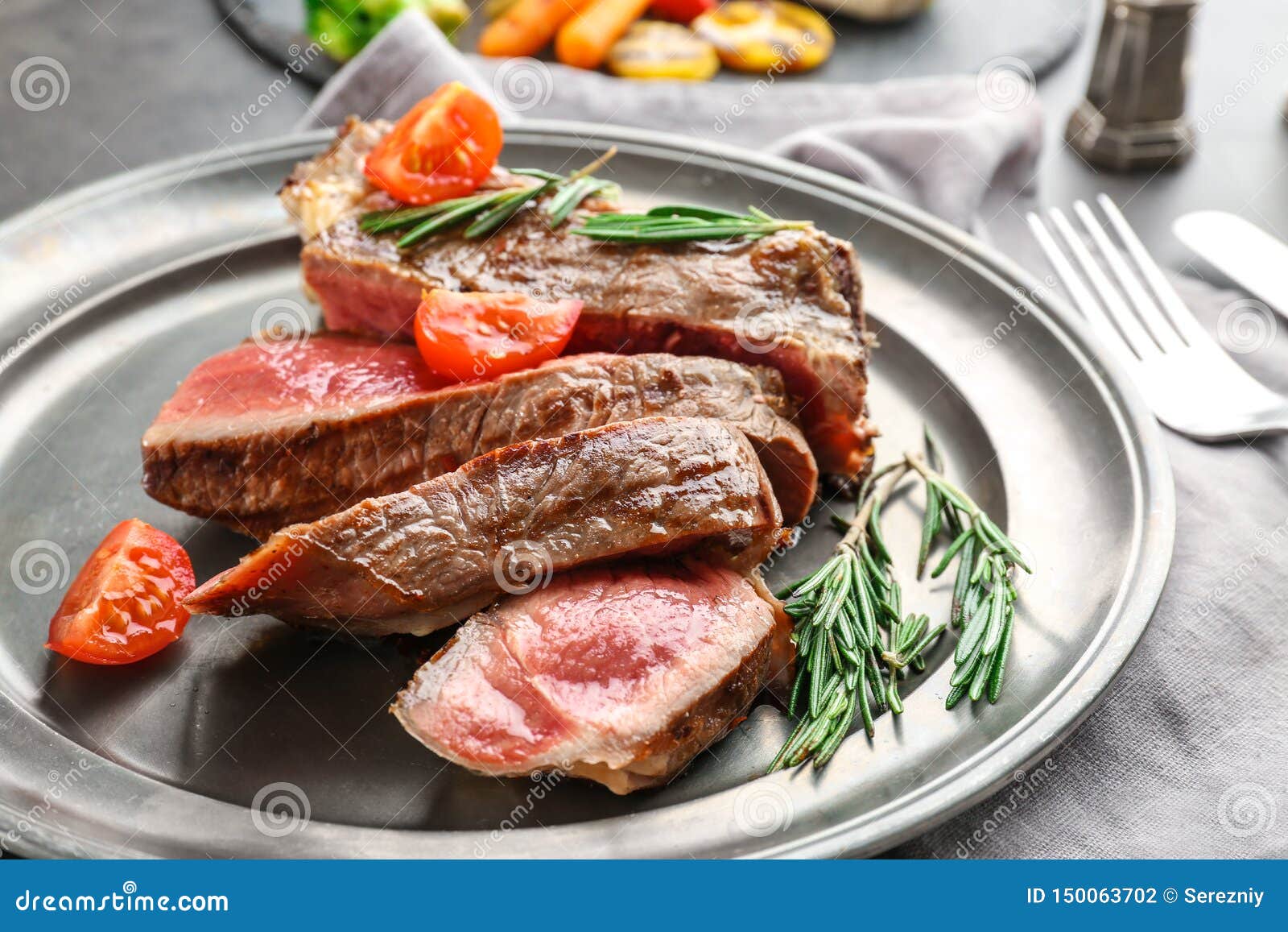 Plate with Meat and Vegetable Garnish on Table Stock Photo - Image of ...