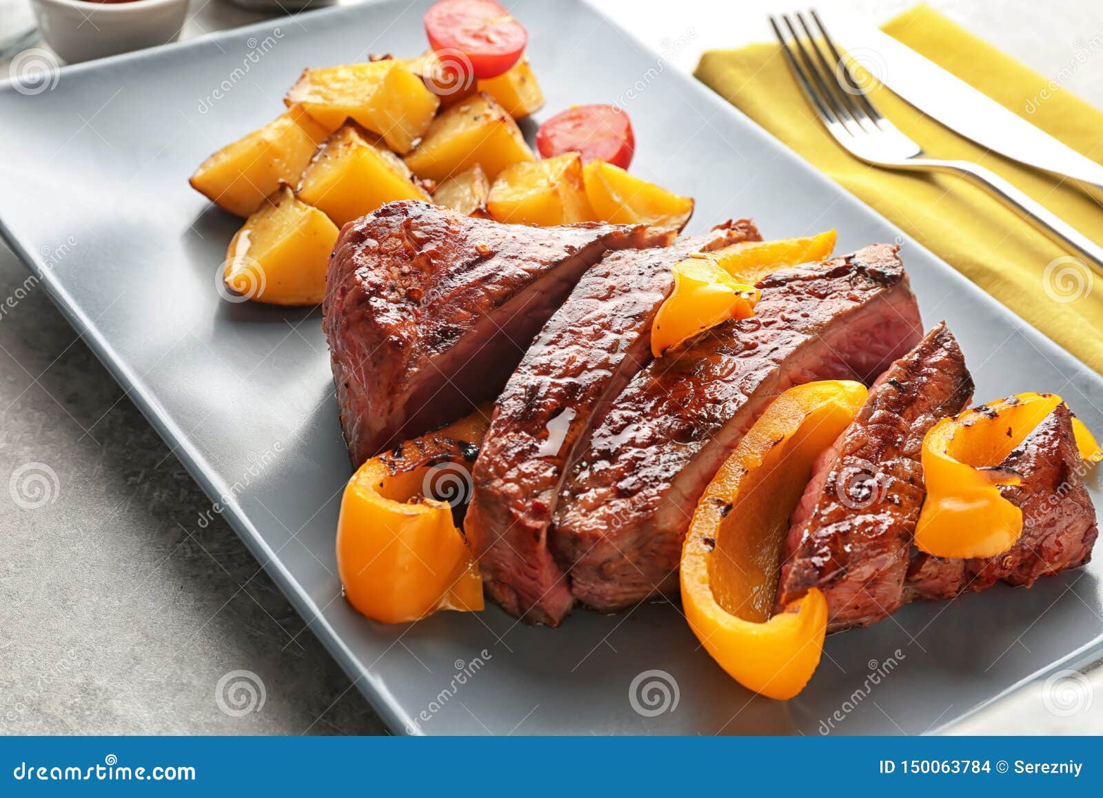 Plate with Meat and Vegetable Garnish on Table Stock Photo - Image of ...