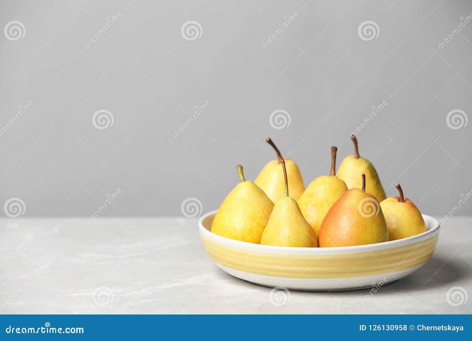 Plate with Pears on Table Against Grey Background Stock Photo - Image ...