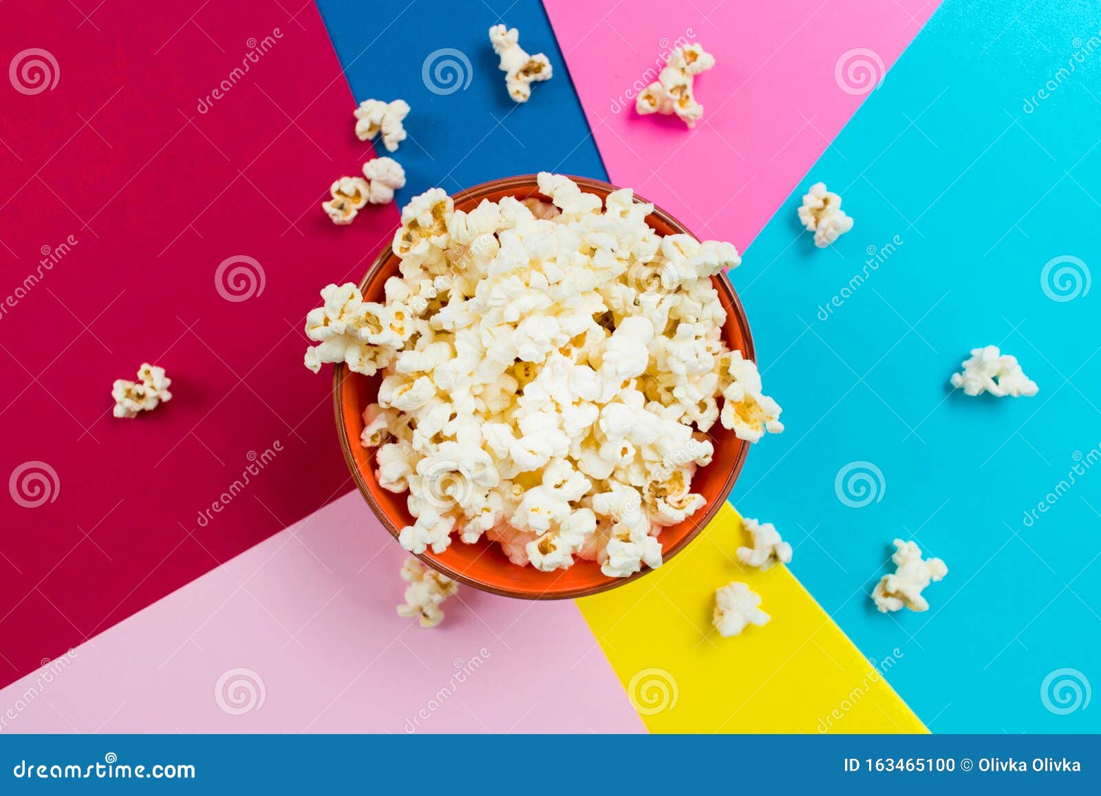 Plate with Popcorn on a Bright Multi-colored Background. Top View ...