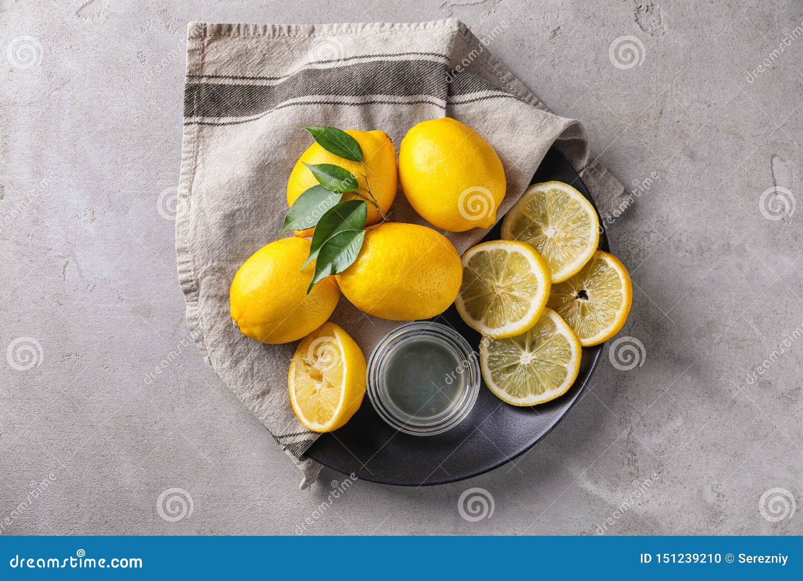 Plate with Ripe Lemons and Bowl of Juice on Grey Table Stock Photo ...