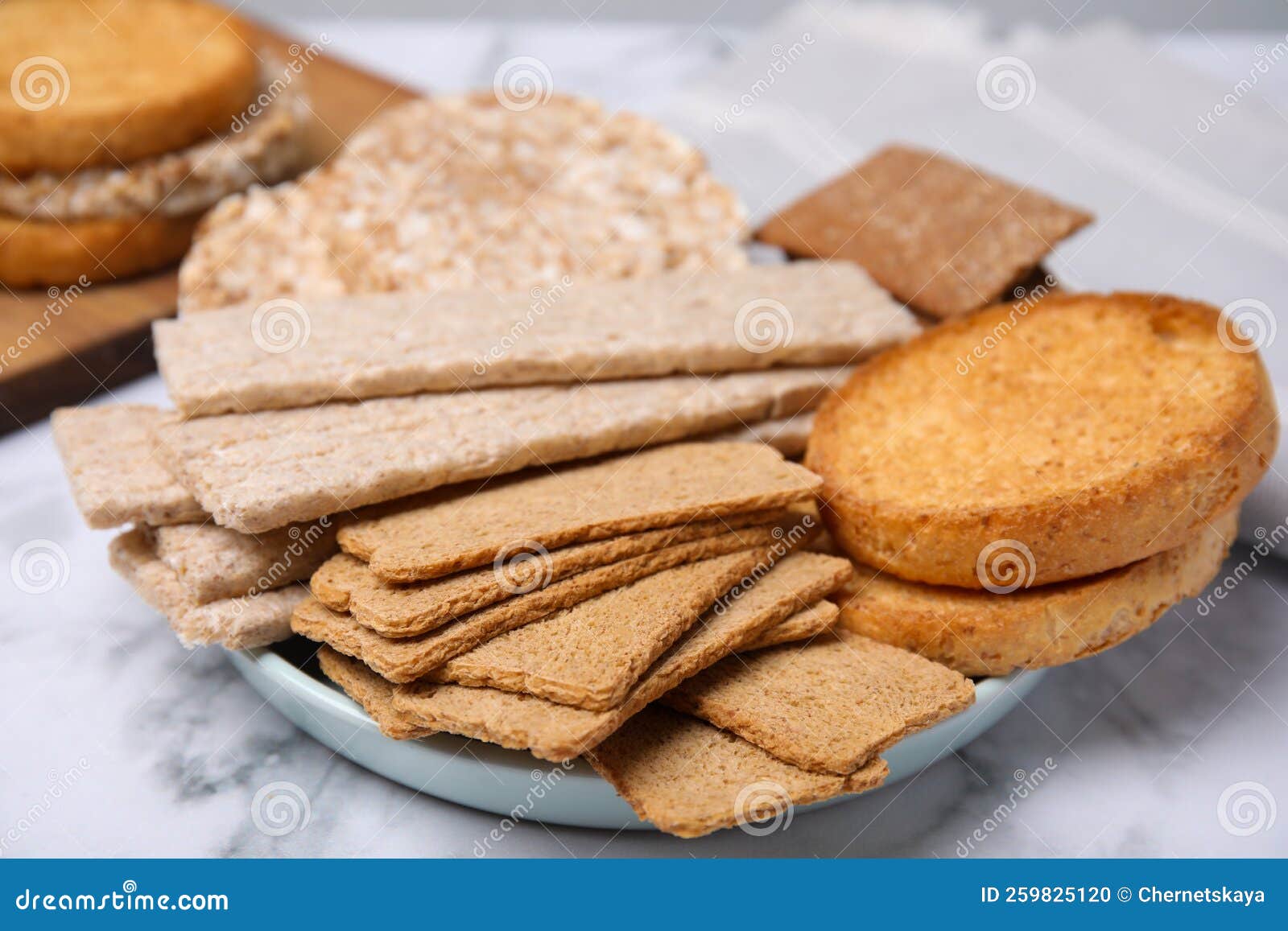 Plate of Rye Crispbreads, Rice Cakes and Rusks on White Marble Table ...