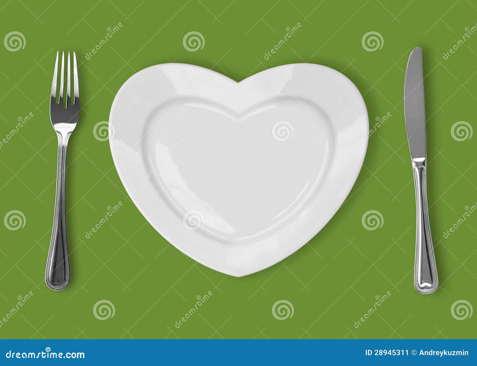Plate in Shape of Heart, Table Knife and Fork on Green Background Stock ...