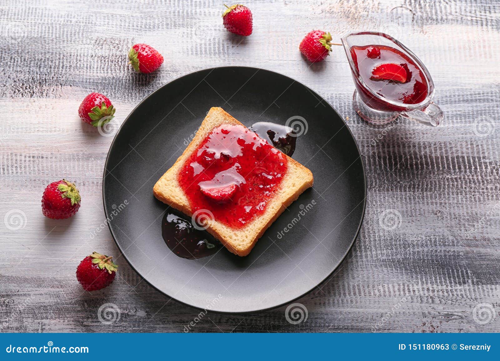 Plate with Slice of Bread and Delicious Strawberry Jam on Wooden Table ...
