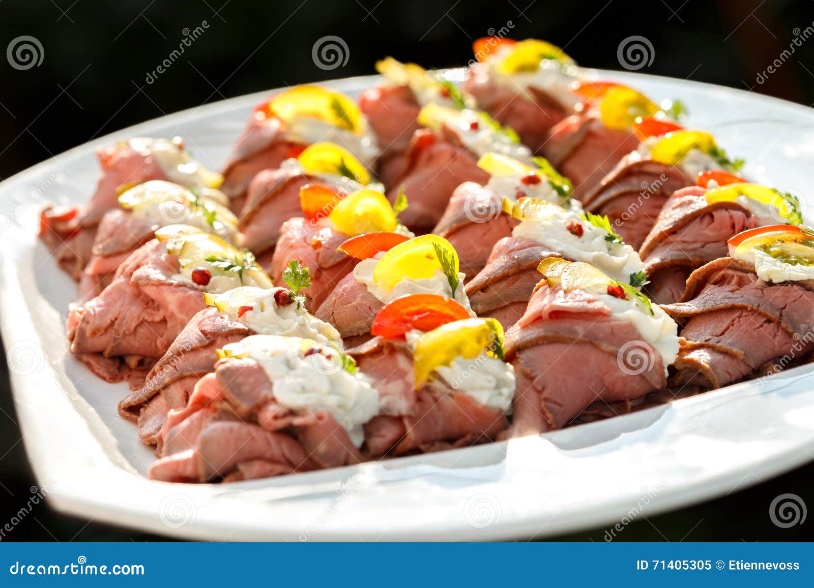 Plate of Sliced, Rolled and Garnished Roast Beef Canapes. on Black ...