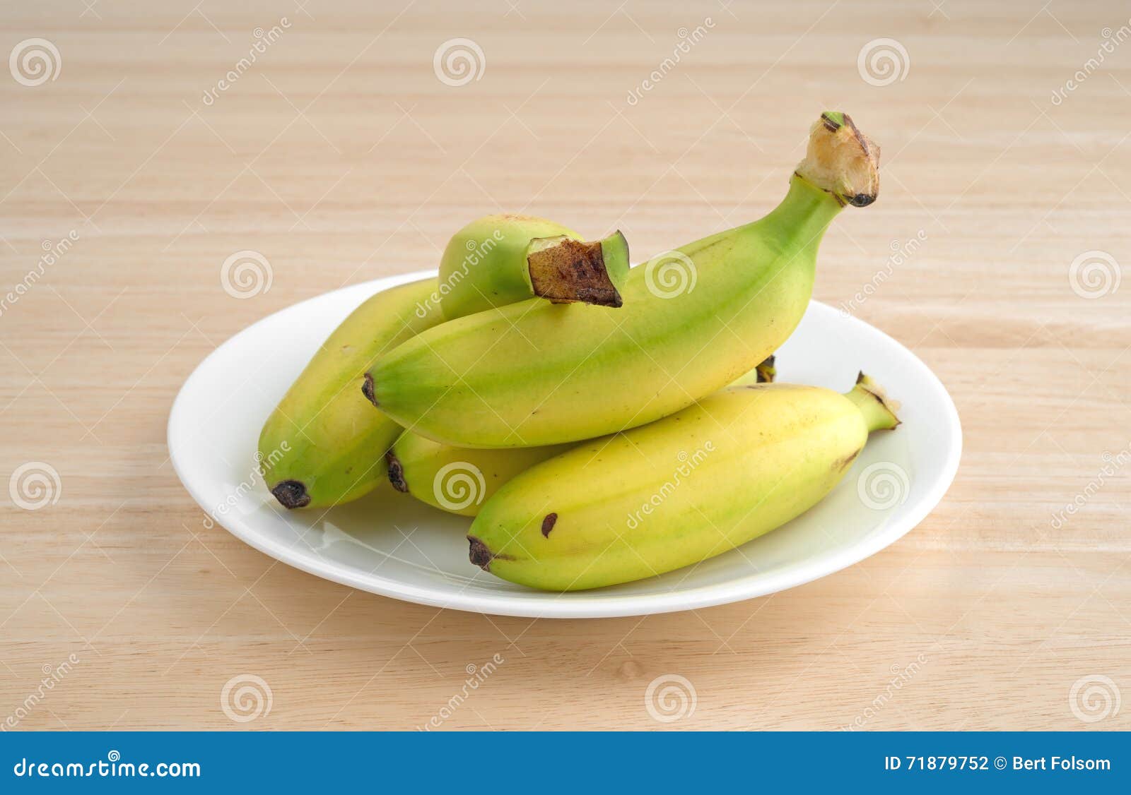 Plate of Small Bananas on a Wood Table Stock Photo - Image of green ...