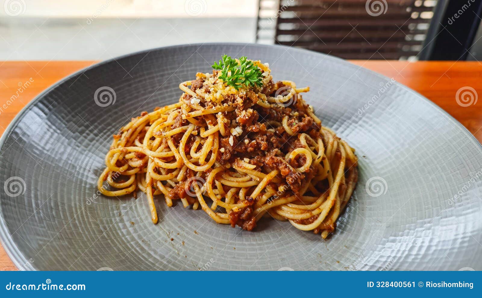 Plate of Spaghetti Bolognese on Grey Plate on Wooden Table in ...