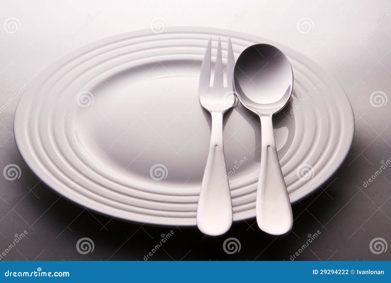 Plate with Spoon and Fork stock photo. Image of ceramic - 29294222