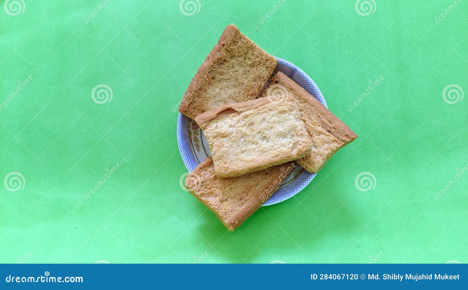 A Plate of Toast Biscuit on a Green Surface Stock Photo - Image of meal ...