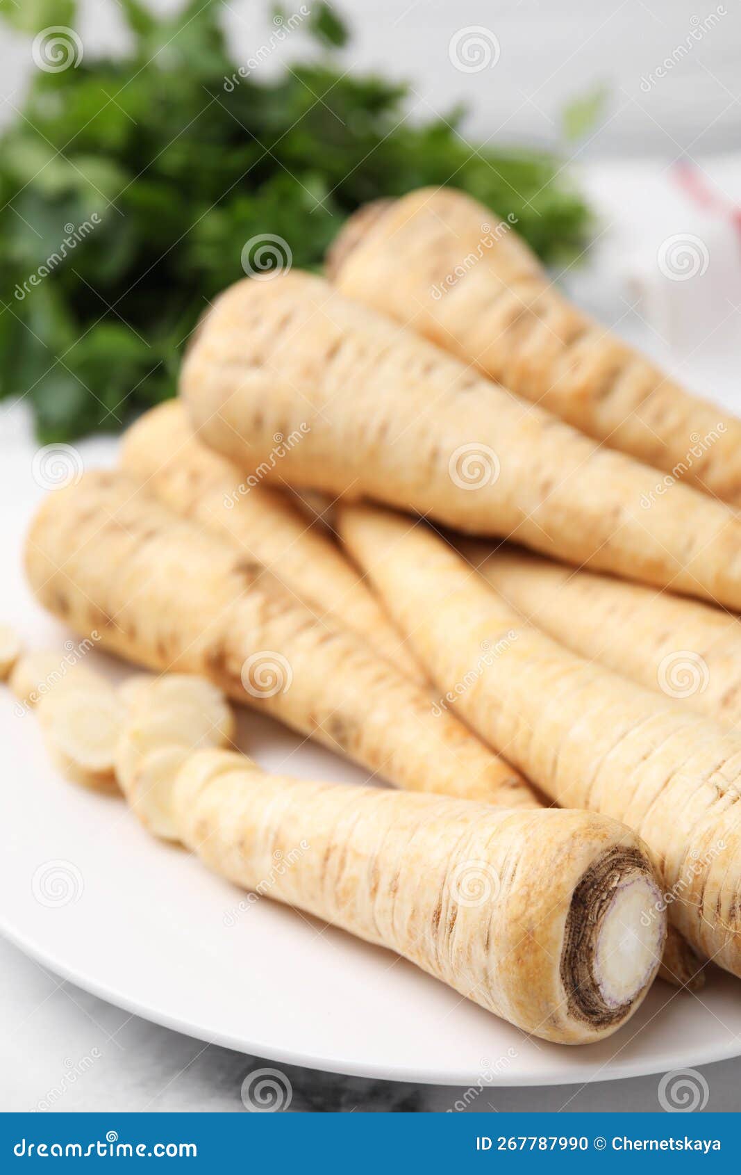 Plate with Whole and Cut Parsley Roots on White Table, Closeup Stock ...