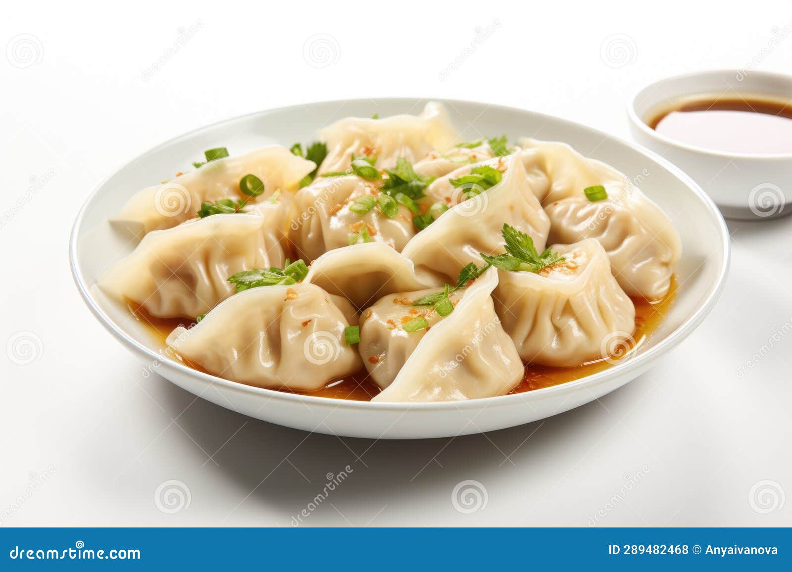 A Plate of Wonton Dumplings and a Bowl of Sauce. Stock Photo - Image of ...
