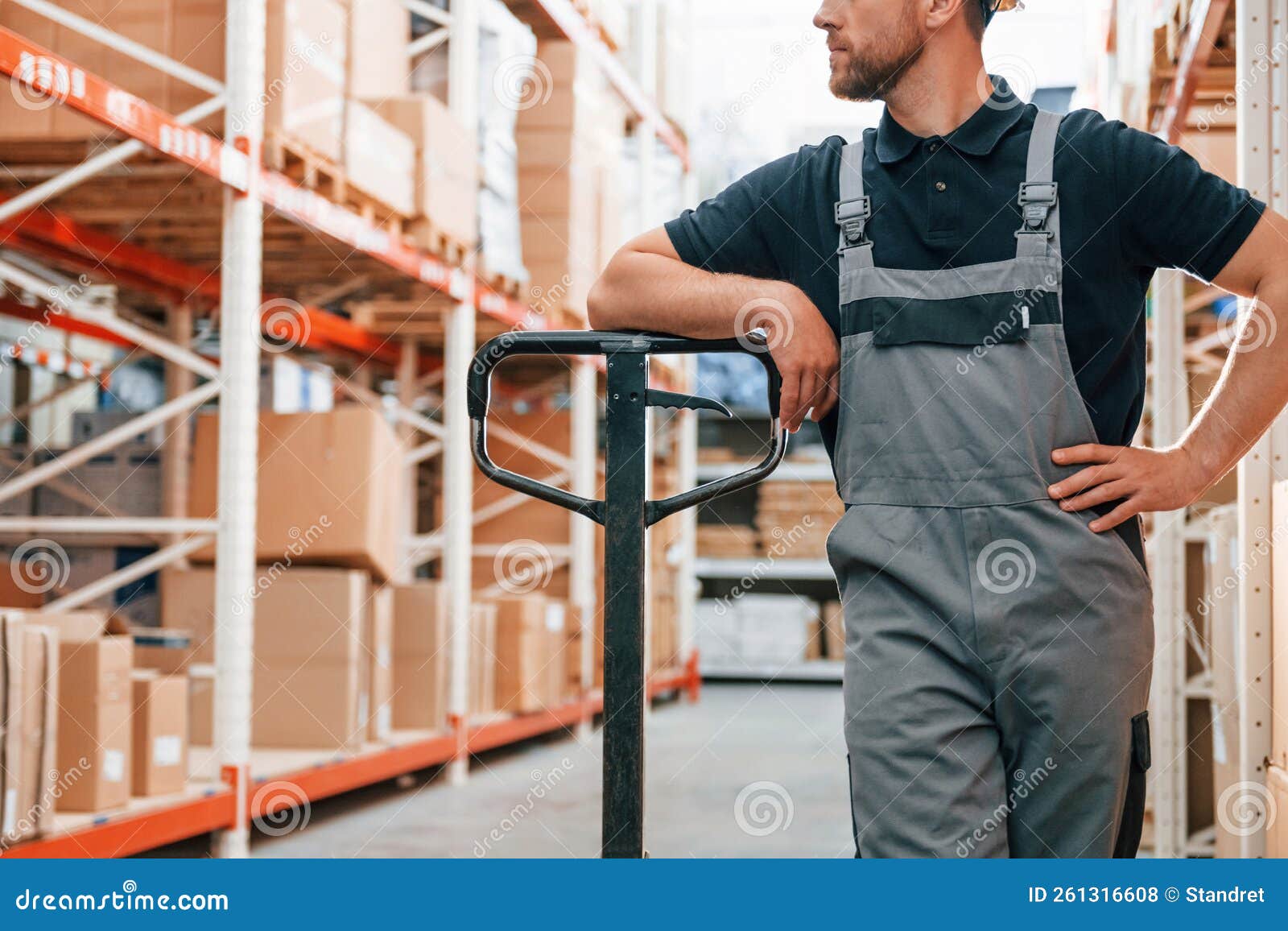 With Platform Trolley. Employee in Uniform is Working in the Storage at ...