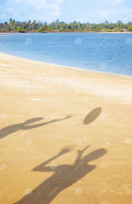 Play at the beach stock image. Image of shadow, jump - 13723709