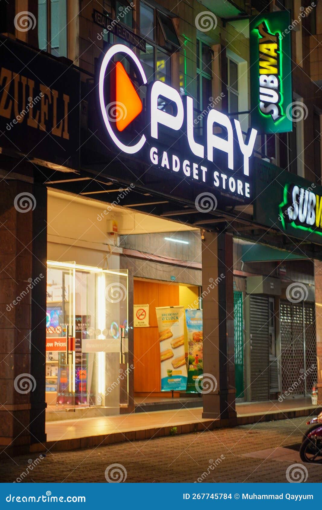 Play Gadget Store with Subway Signboard Glowing at Night Editorial ...