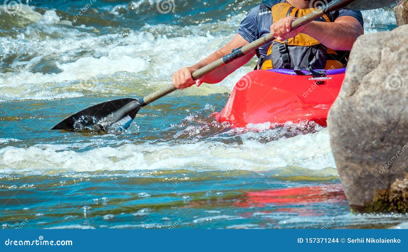 Playboating A Man Sitting In A Kayak With Oars In His Hands Performs Exercises On The Water