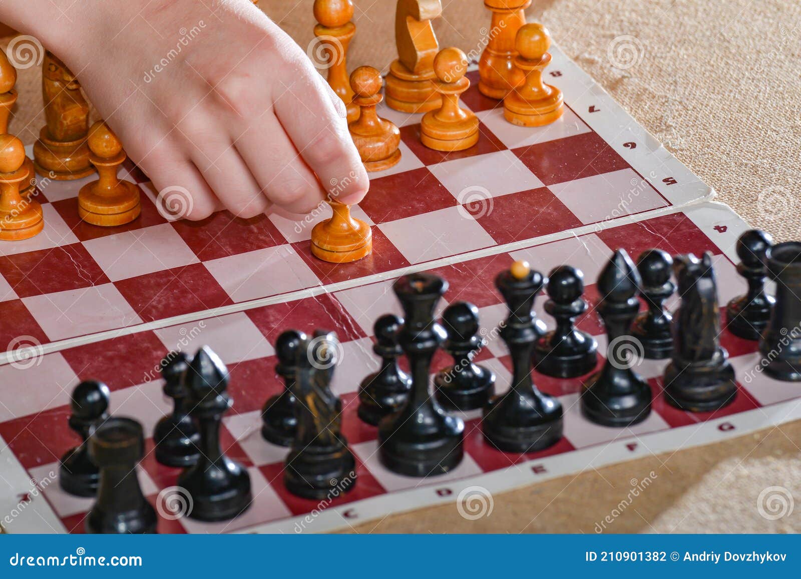 The Player Holds a White Pawn in His Hand and Starts the Game of Stock ...