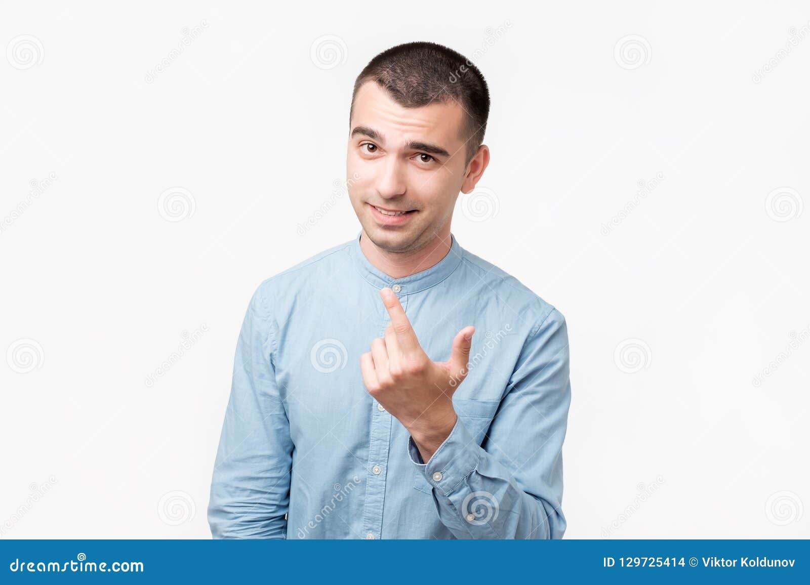 Playful Adult Showing Come Here Gesture with Index Finger and Smiling ... Playful Adult Showing Come Here Gesture with Index Finger and Smiling ...