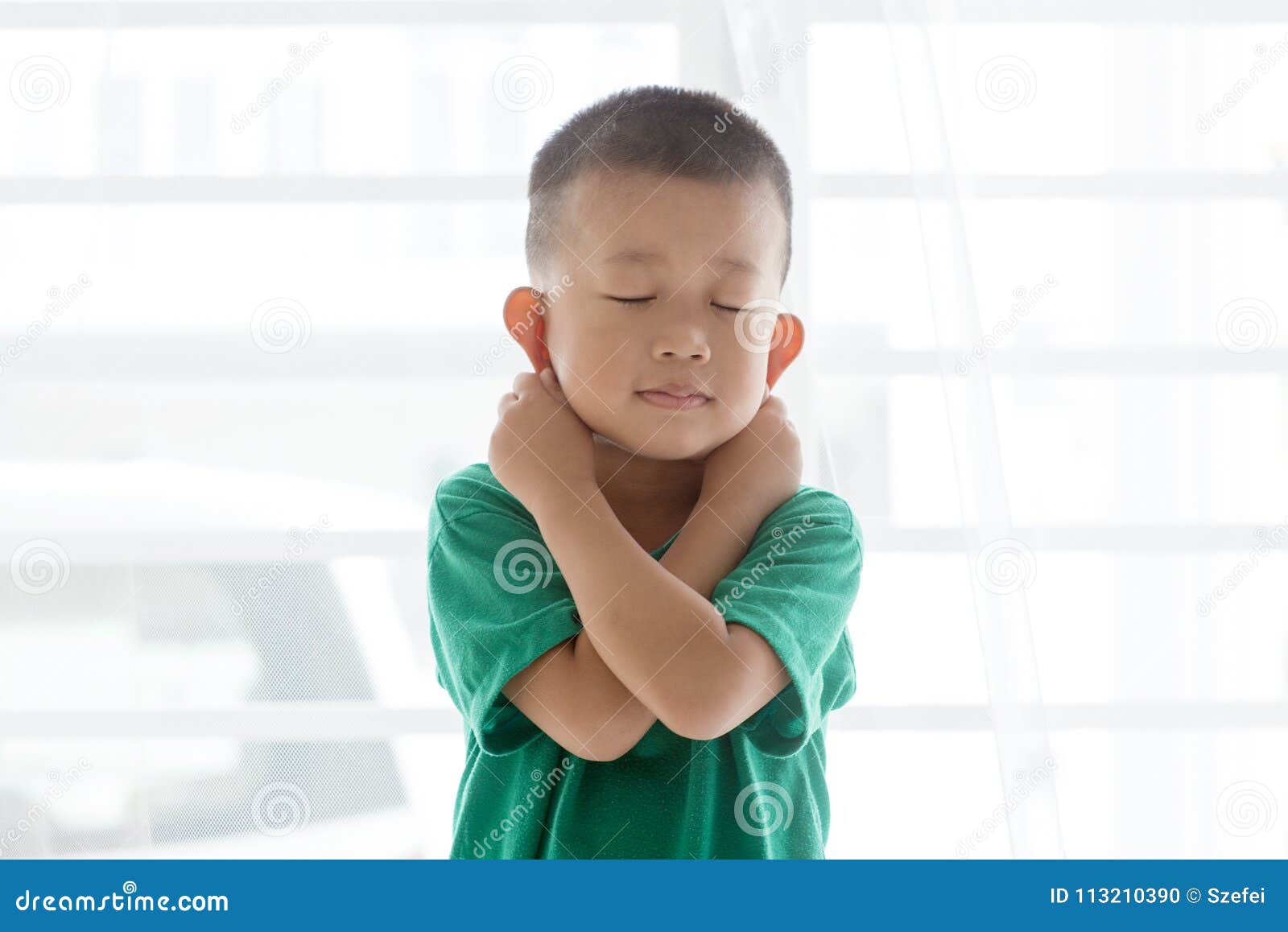 Playful boy pulling ears stock photo. Image of ears - 113210390