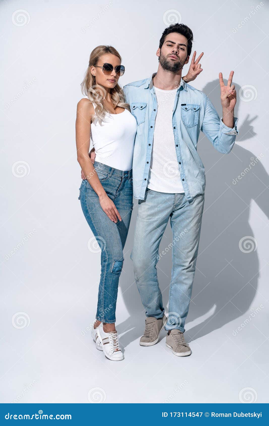 Playful Couple Full Length Of Beautiful Young Couple In Denim Wear