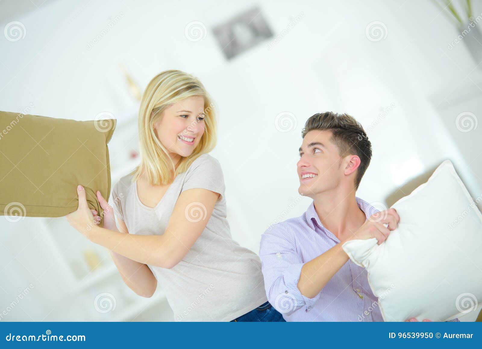 Playful Couple Having Pillow Fight Stock Photo - Image of close ...